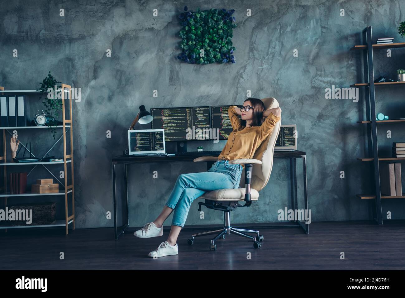 Portrait of attractive dreamy girl technician web developer sitting in ...