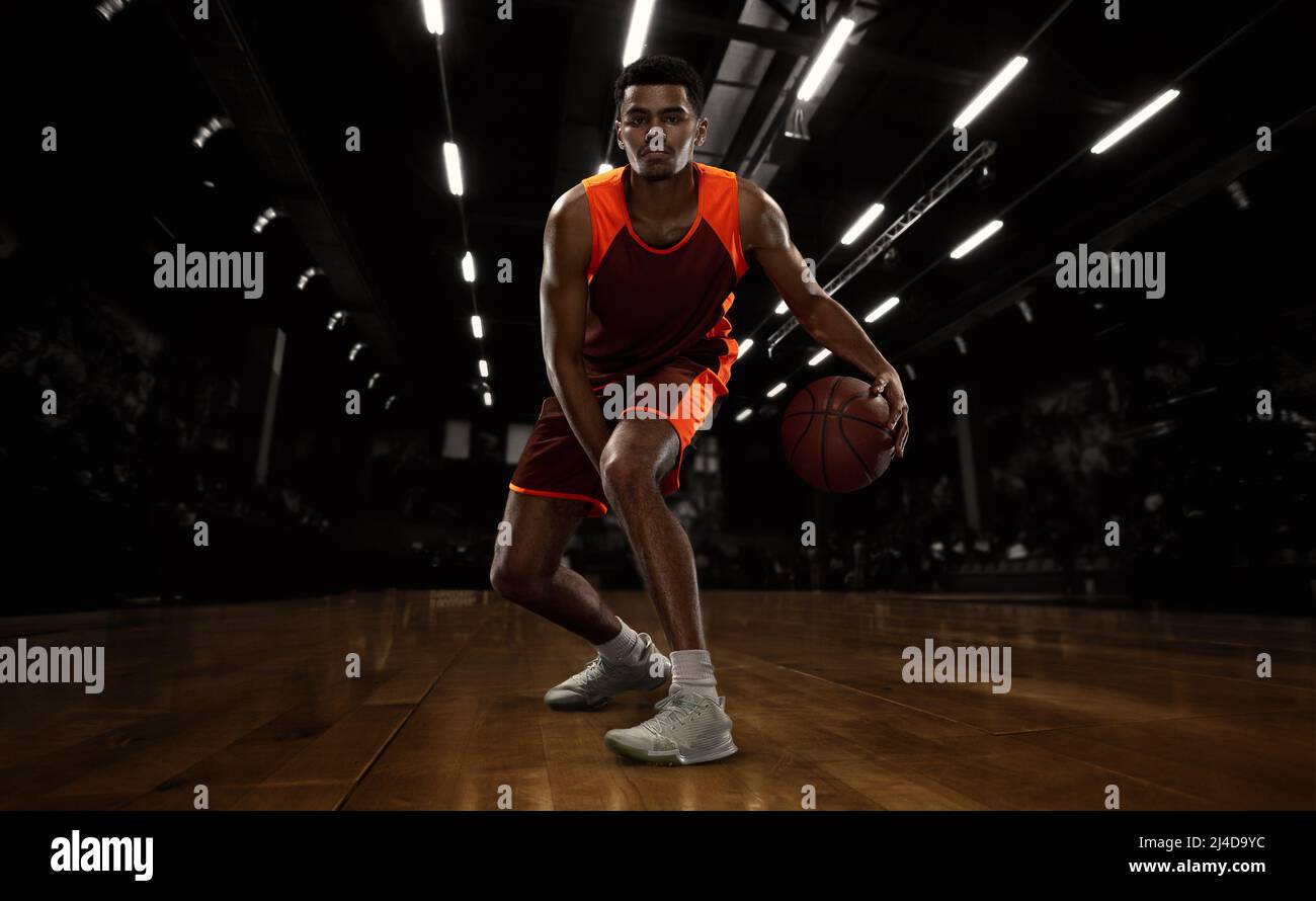 African-american young basketball player in action and motion in ...