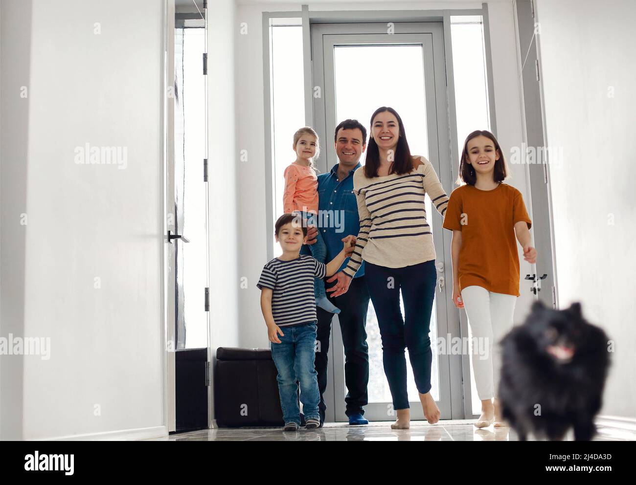 Excited kids arriving home with their parents. Children returning home ...