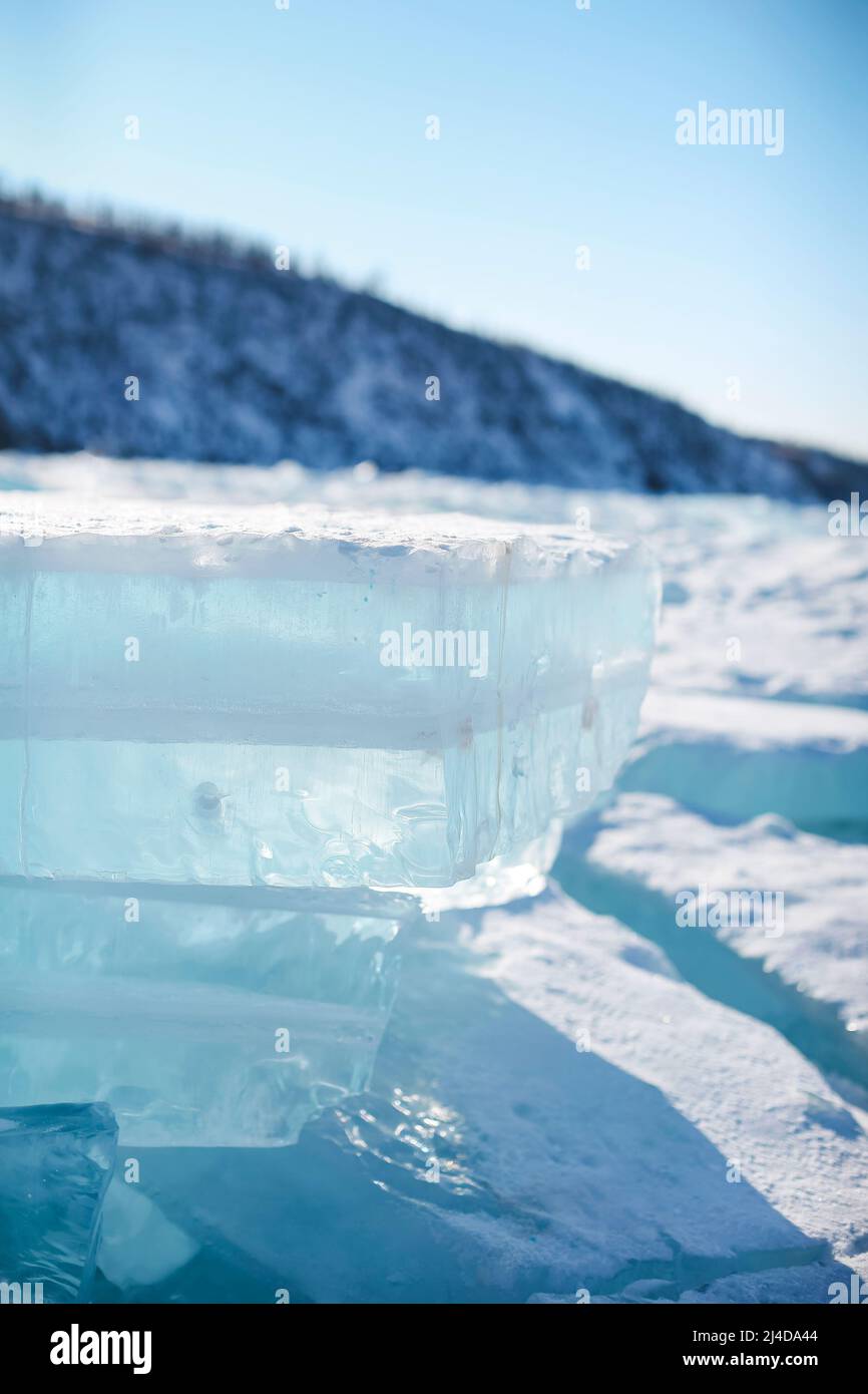 Pieces of ice lying on the ideal smooth ice of baikal with ice hummocks ...