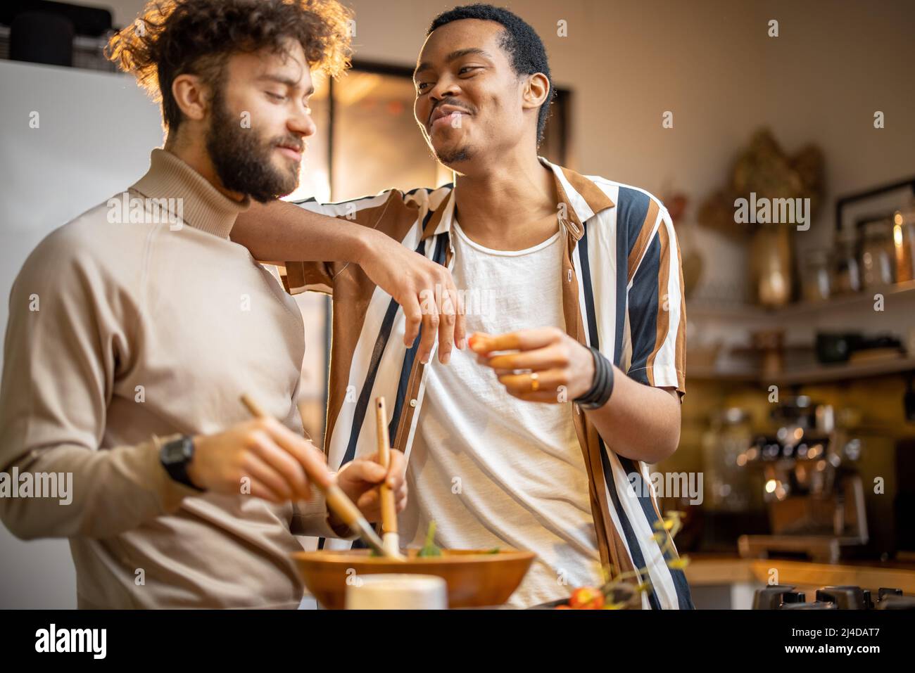 Two guys cooking healthy together at home Stock Photo - Alamy