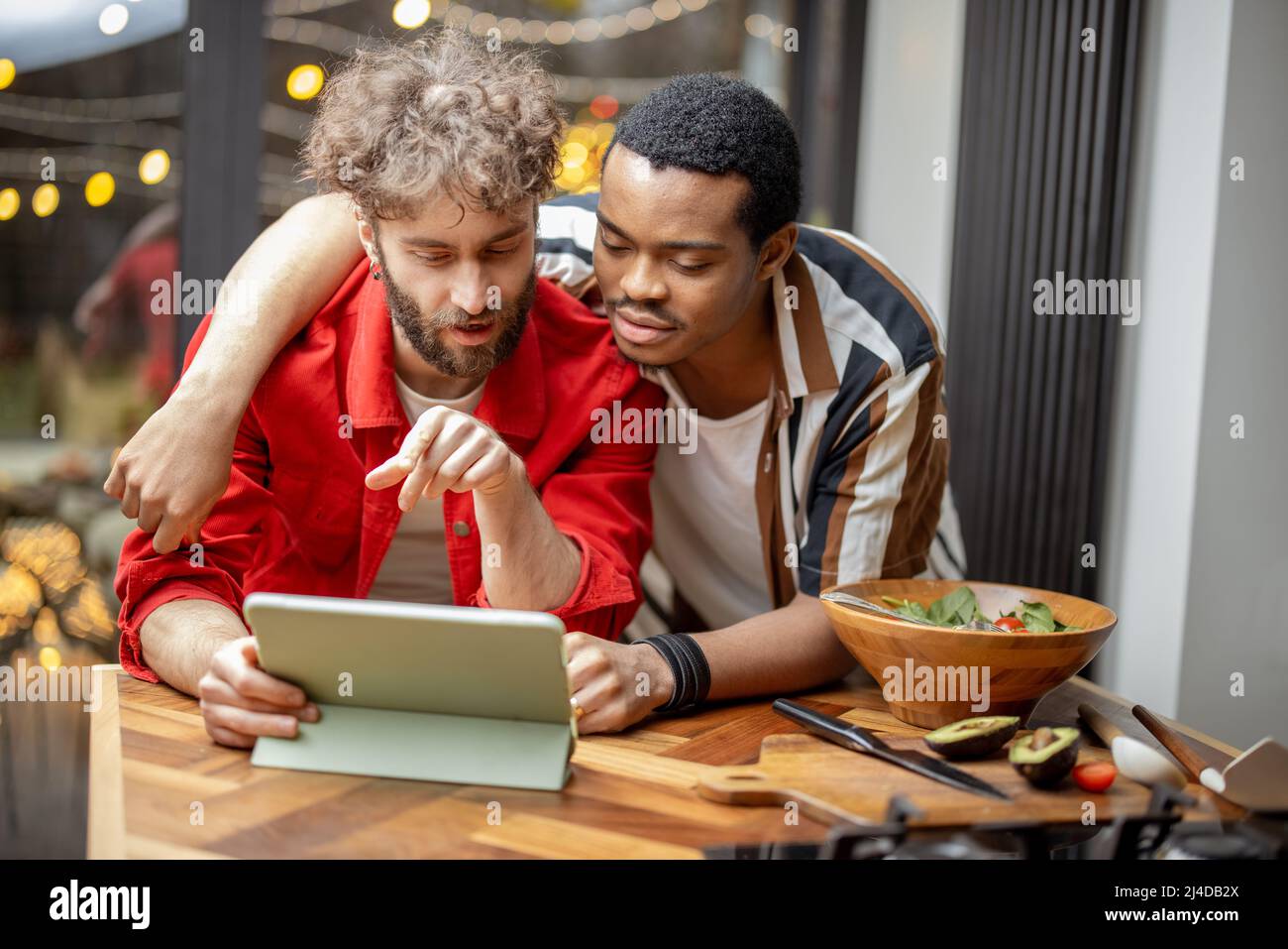 Two guys watching movie together on digital tablet at home Stock Photo ...