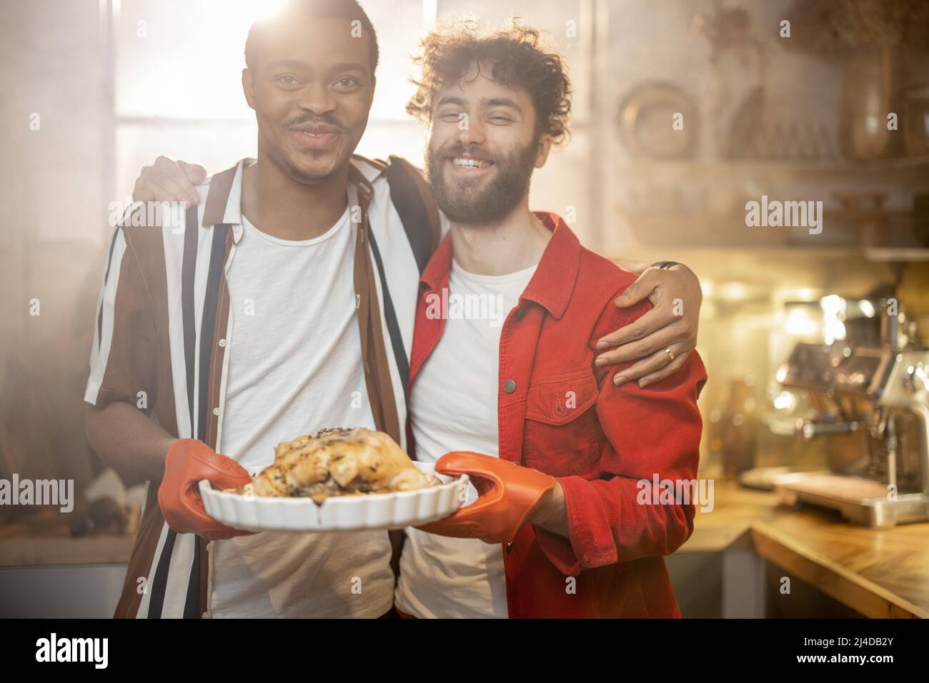 Two guys with cooked meal together on kitchen Stock Photo - Alamy