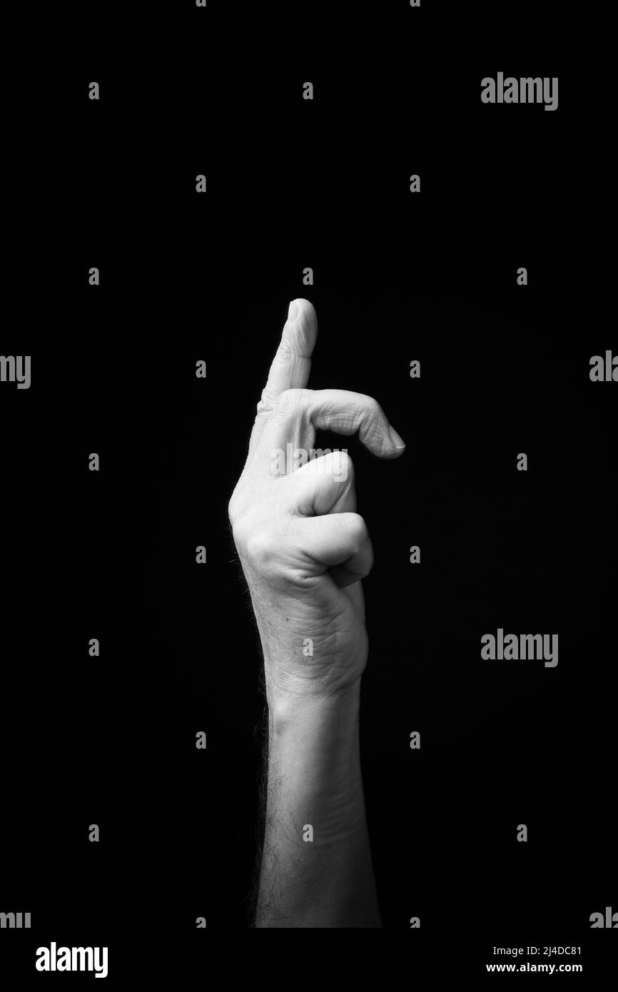 Dramatic black and white image of a male hand fingerspelling the ...