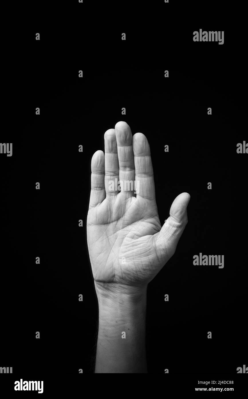 Dramatic black and white image of a male hand fingerspelling the ...