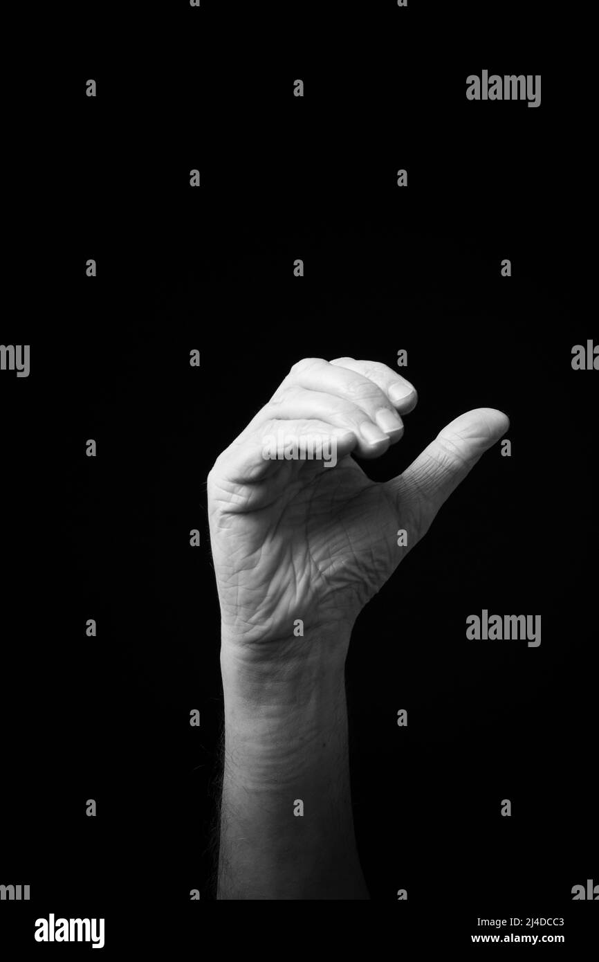 Dramatic black and white image of a male hand fingerspelling the ...