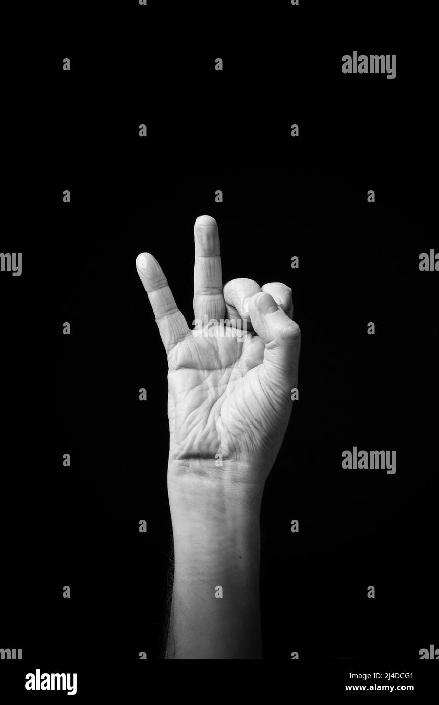 Dramatic black and white image of a male hand fingerspelling the ...