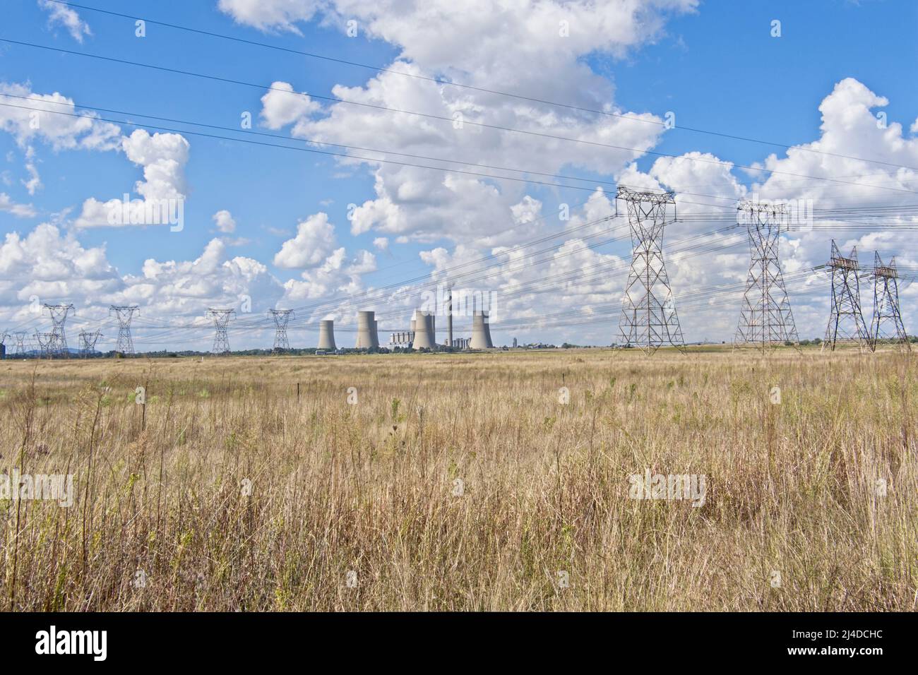 Power line pylons with the power station in the background Stock Photo ...