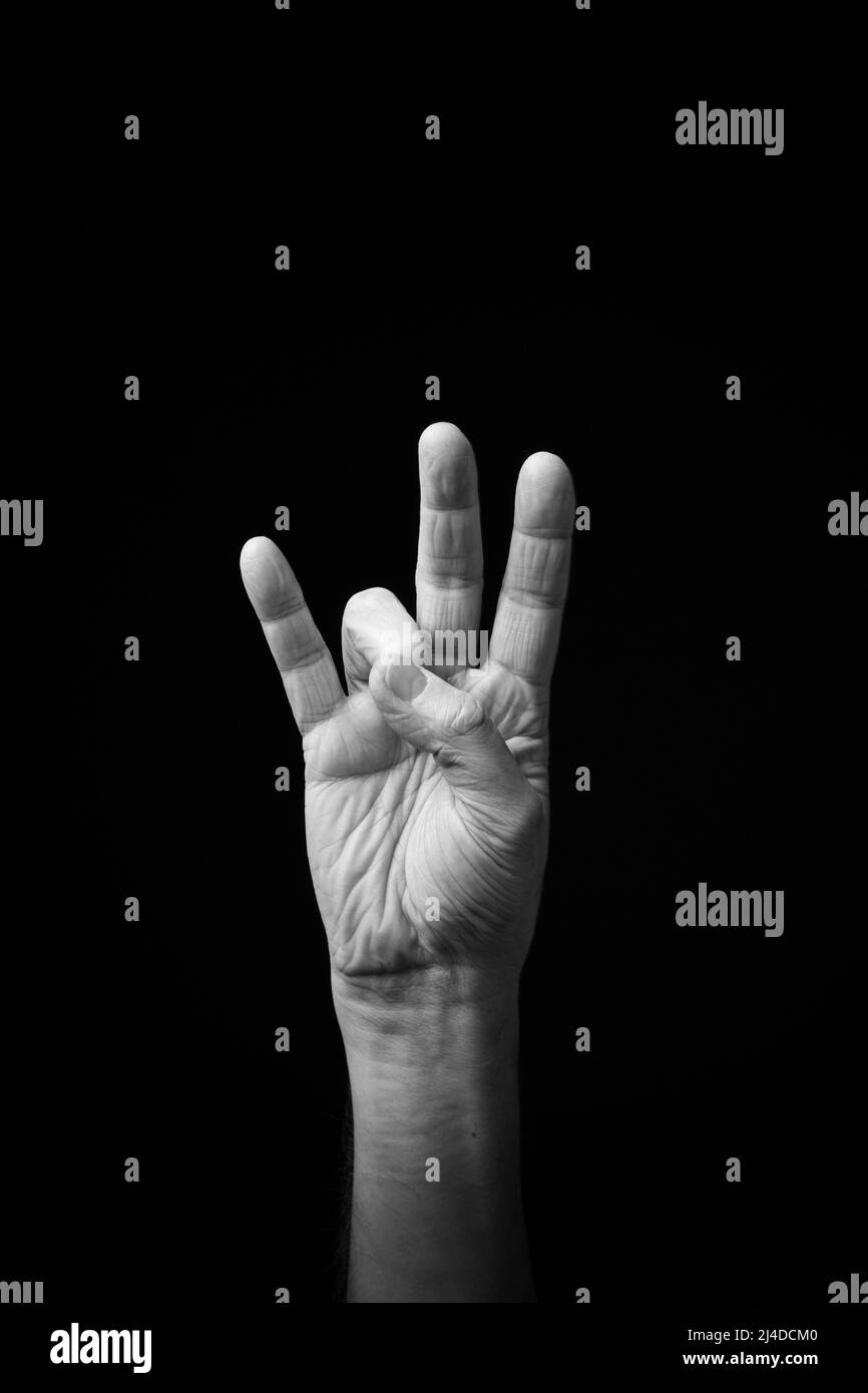 Dramatic black and white image of a male hand fingerspelling the ...