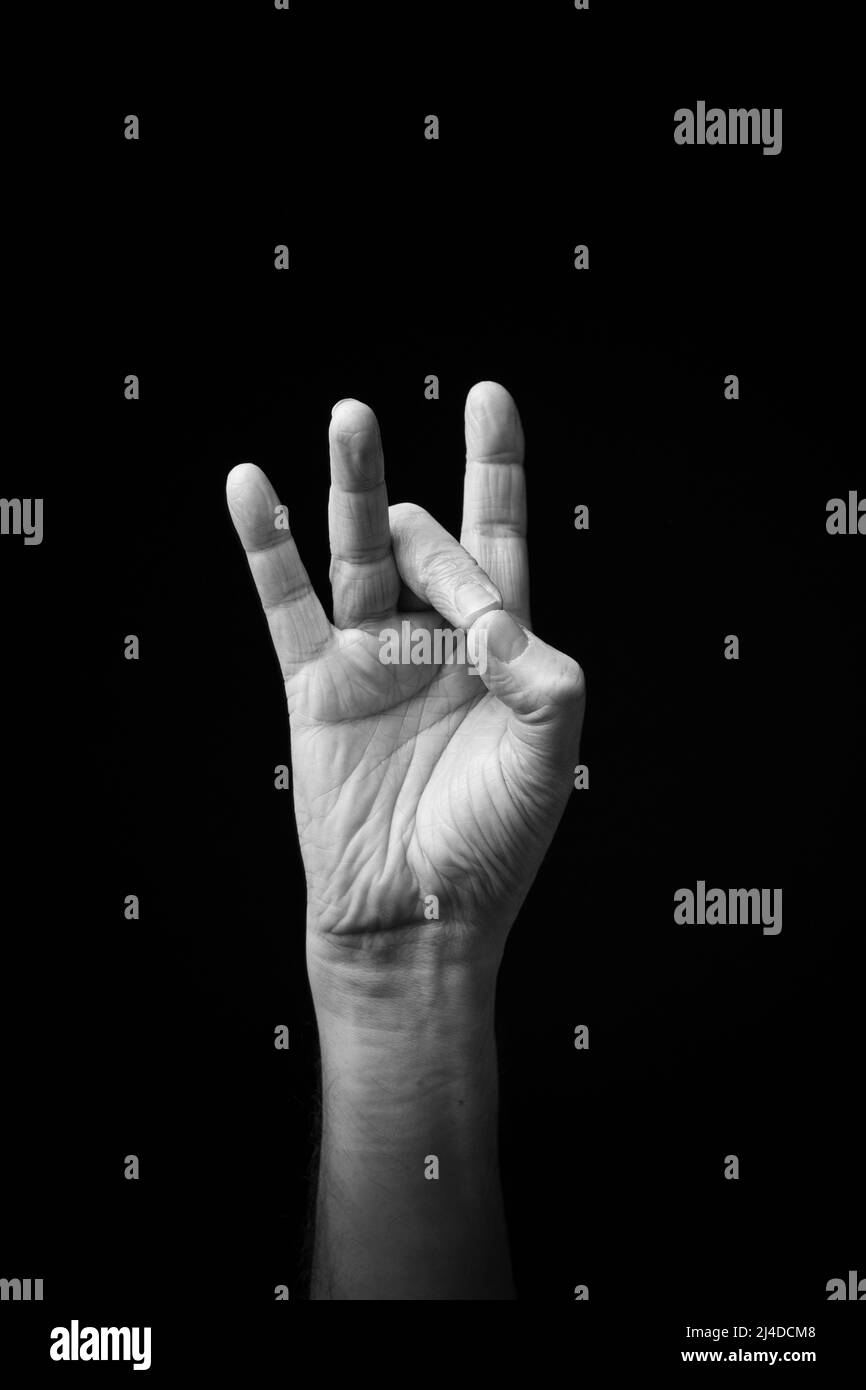 Dramatic black and white image of a male hand fingerspelling the ...