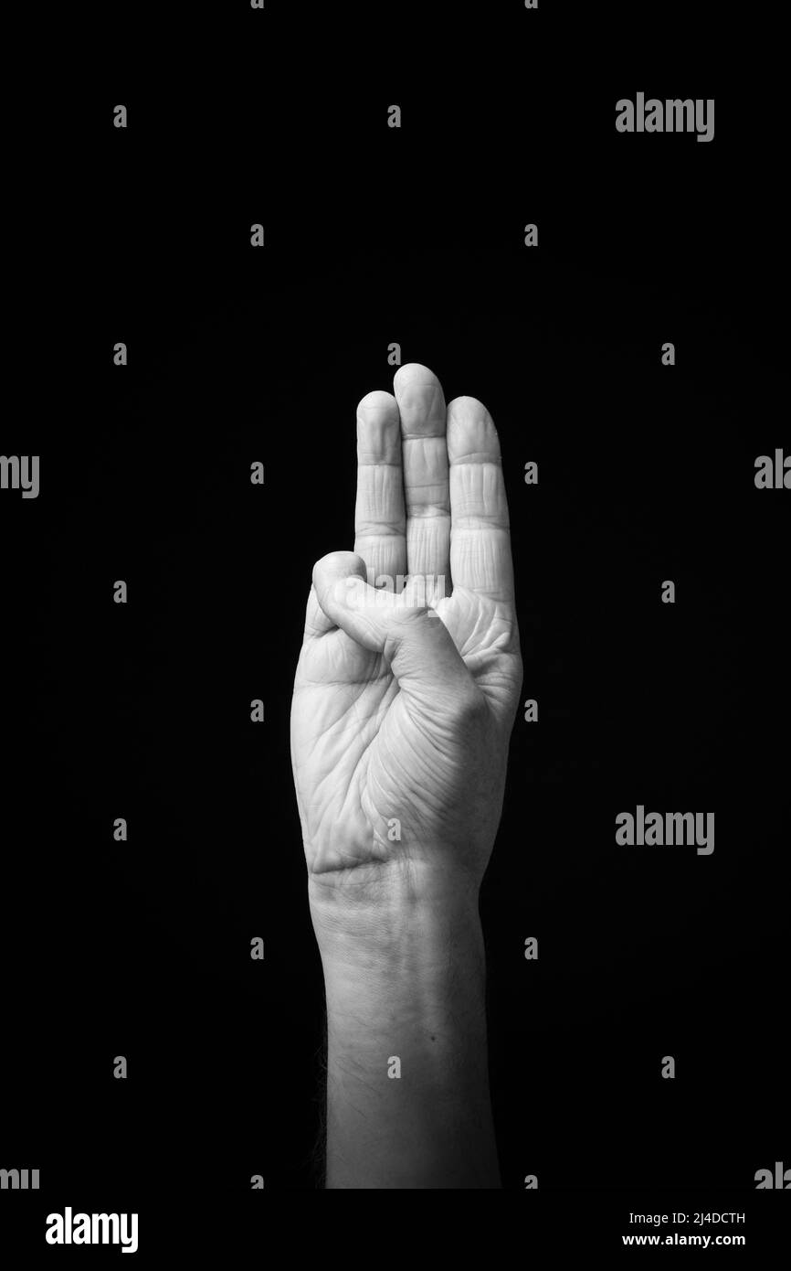 Dramatic black and white image of a male hand fingerspelling the ...