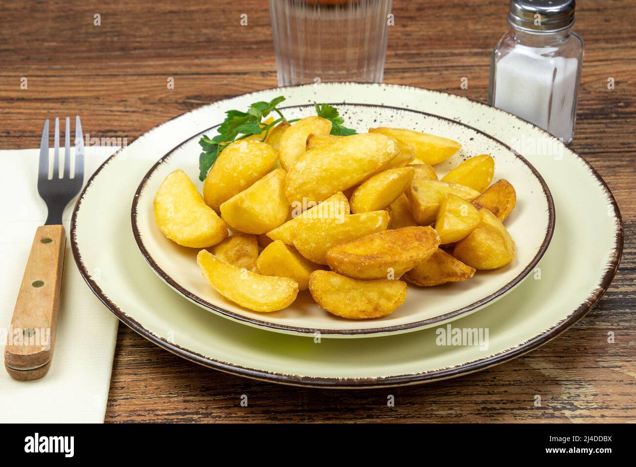 baked potato in a plate on a wooden table Stock Photo - Alamy