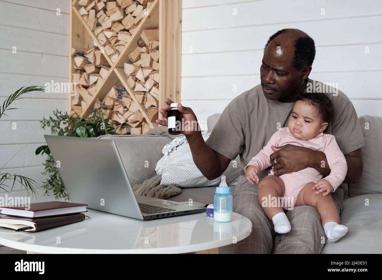 Portrait of caring African American father asking doctor about cough ...