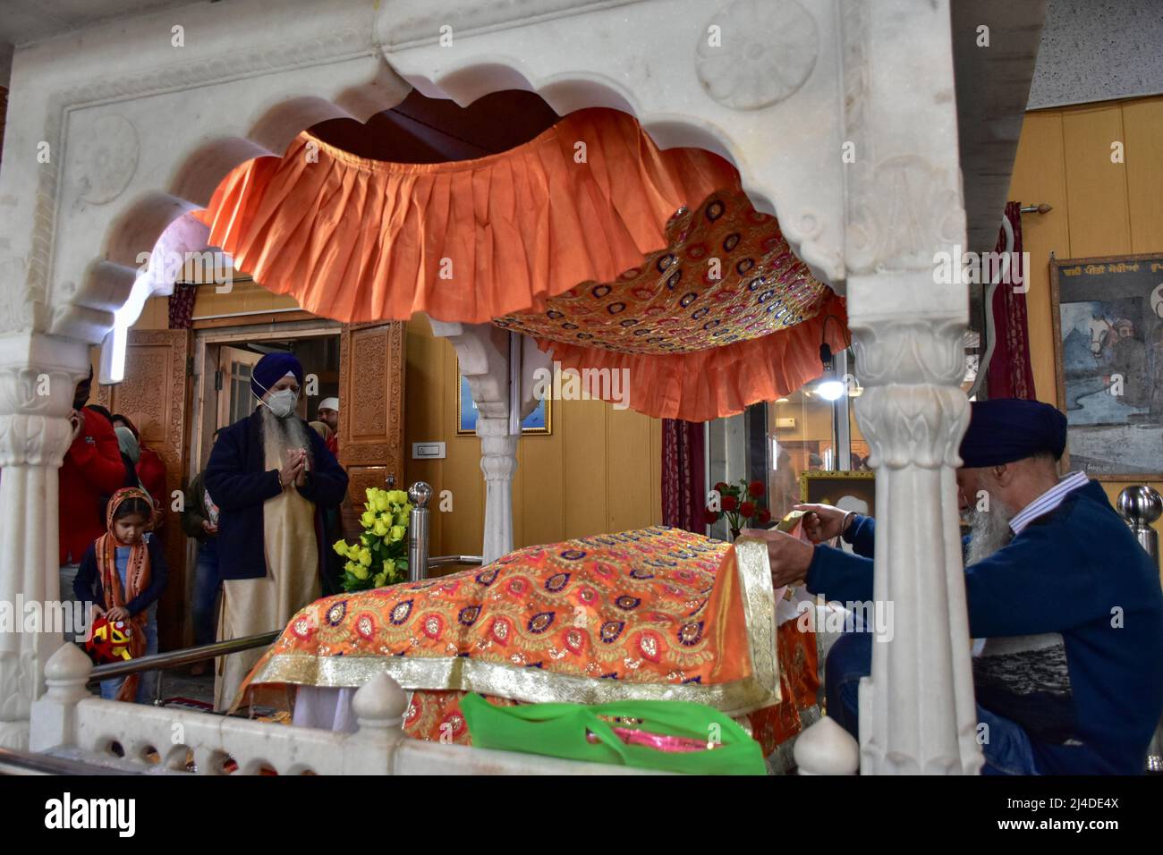 Srinagar, India. 14th Apr, 2022. Sikh devotees pray inside a Gurdwara ...