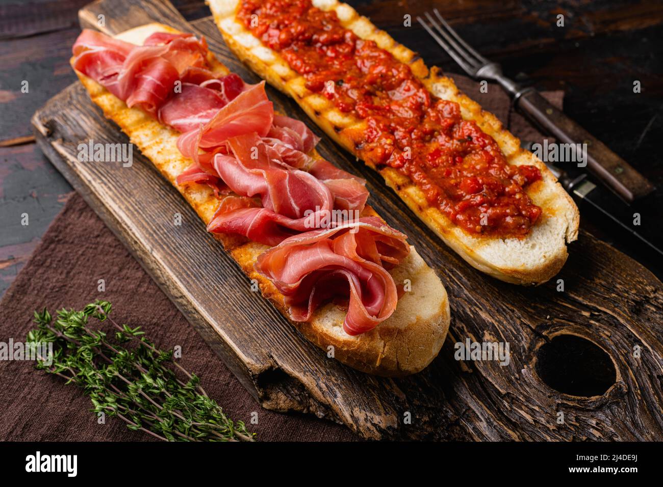Traditional Spanish Jamon Serrano ham, on old dark wooden table ...