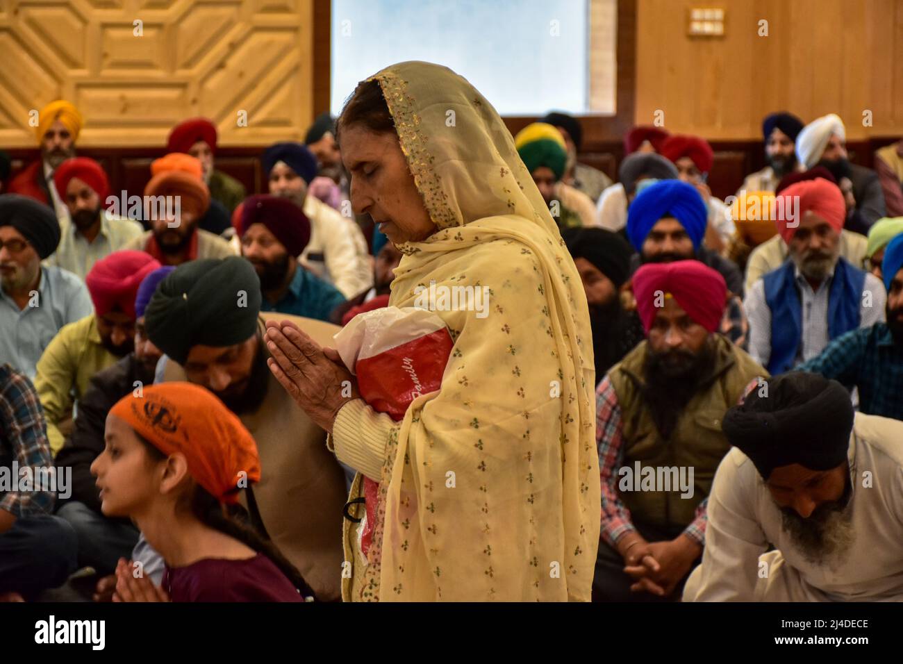 Srinagar, India. 14th Apr, 2022. A Sikh devotee prays inside a Gurdwara ...