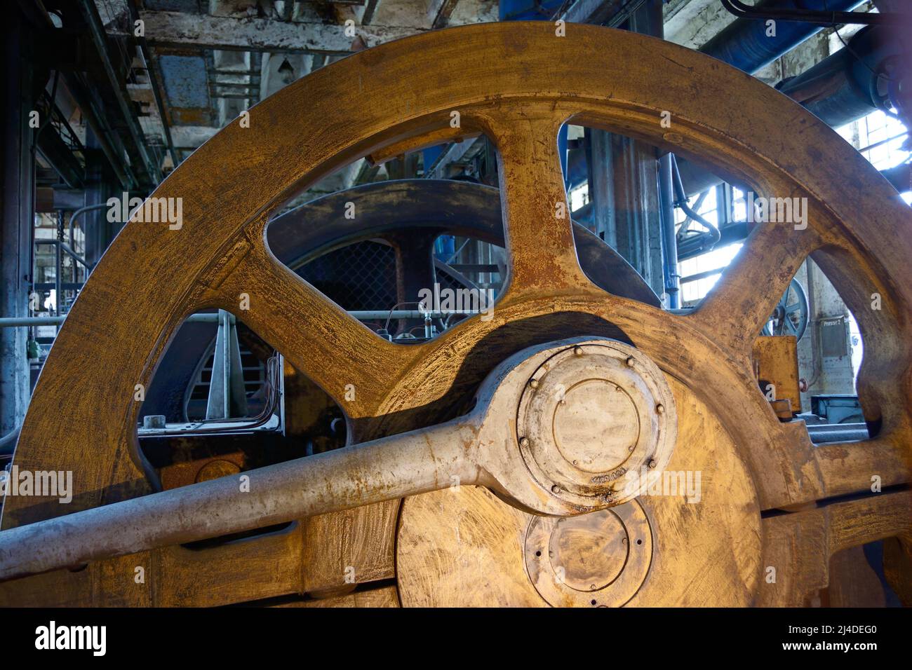 Historical machine wheel in factory building Stock Photo - Alamy