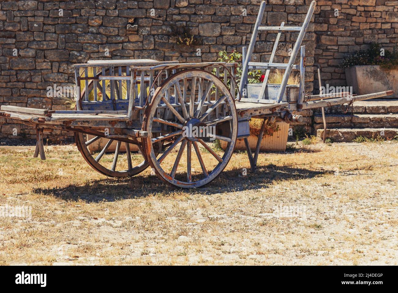 Medieval wooden vehicle with metal tire on wheel rim ready to move ...