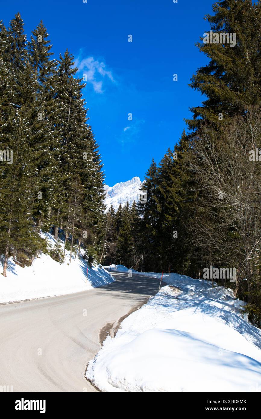 Snowy alpine country road to Mountain Loser in the austrian alps ...