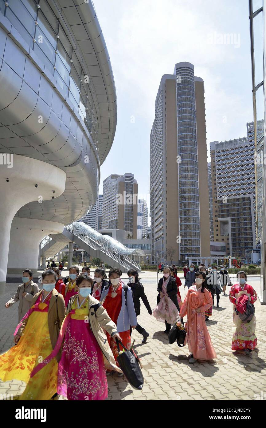 People walk by high-rise condominiums in Pyongyang on April 14, 2022, a ...