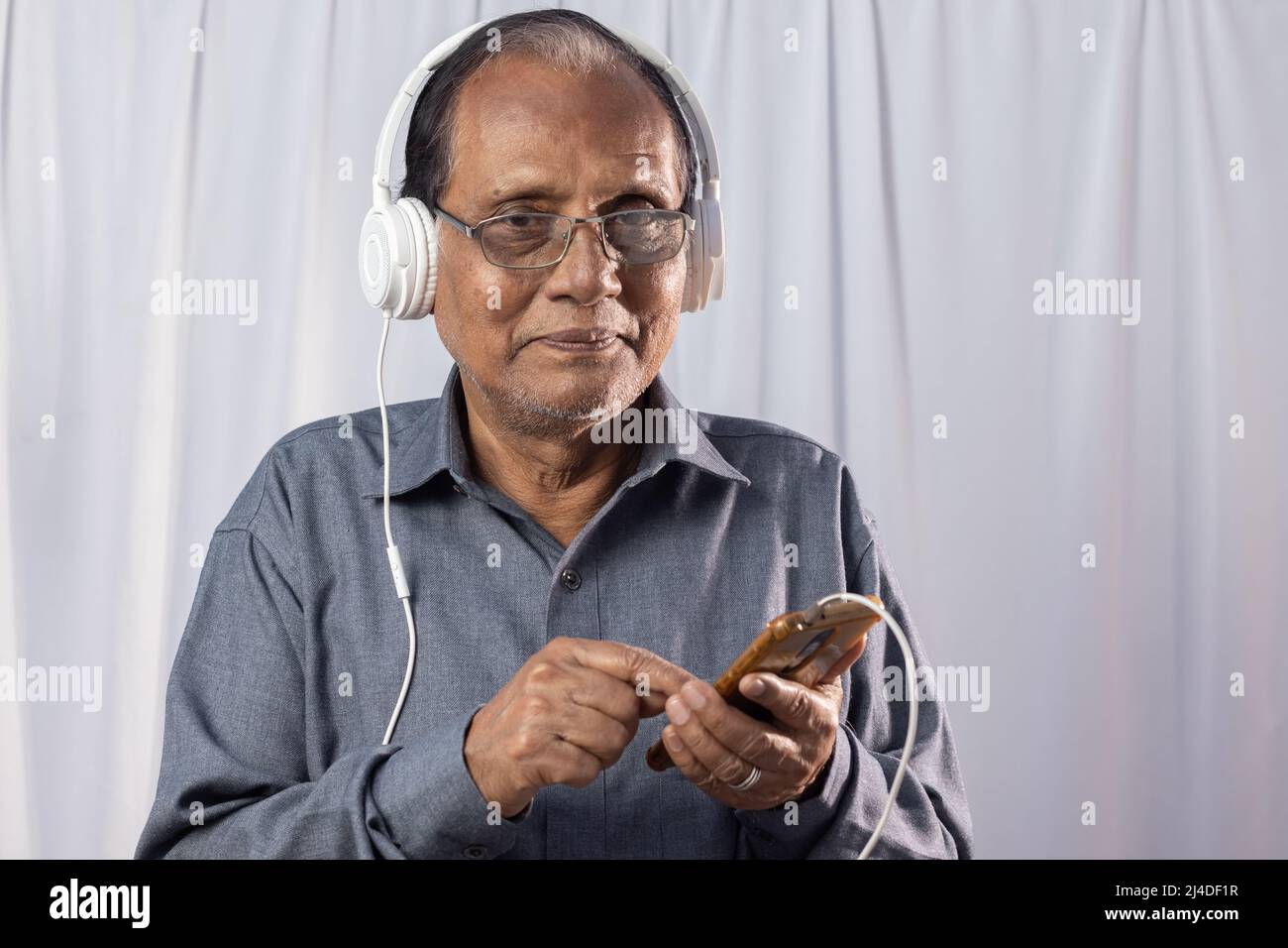 Old man headset looking camera hi-res stock photography and images - Alamy