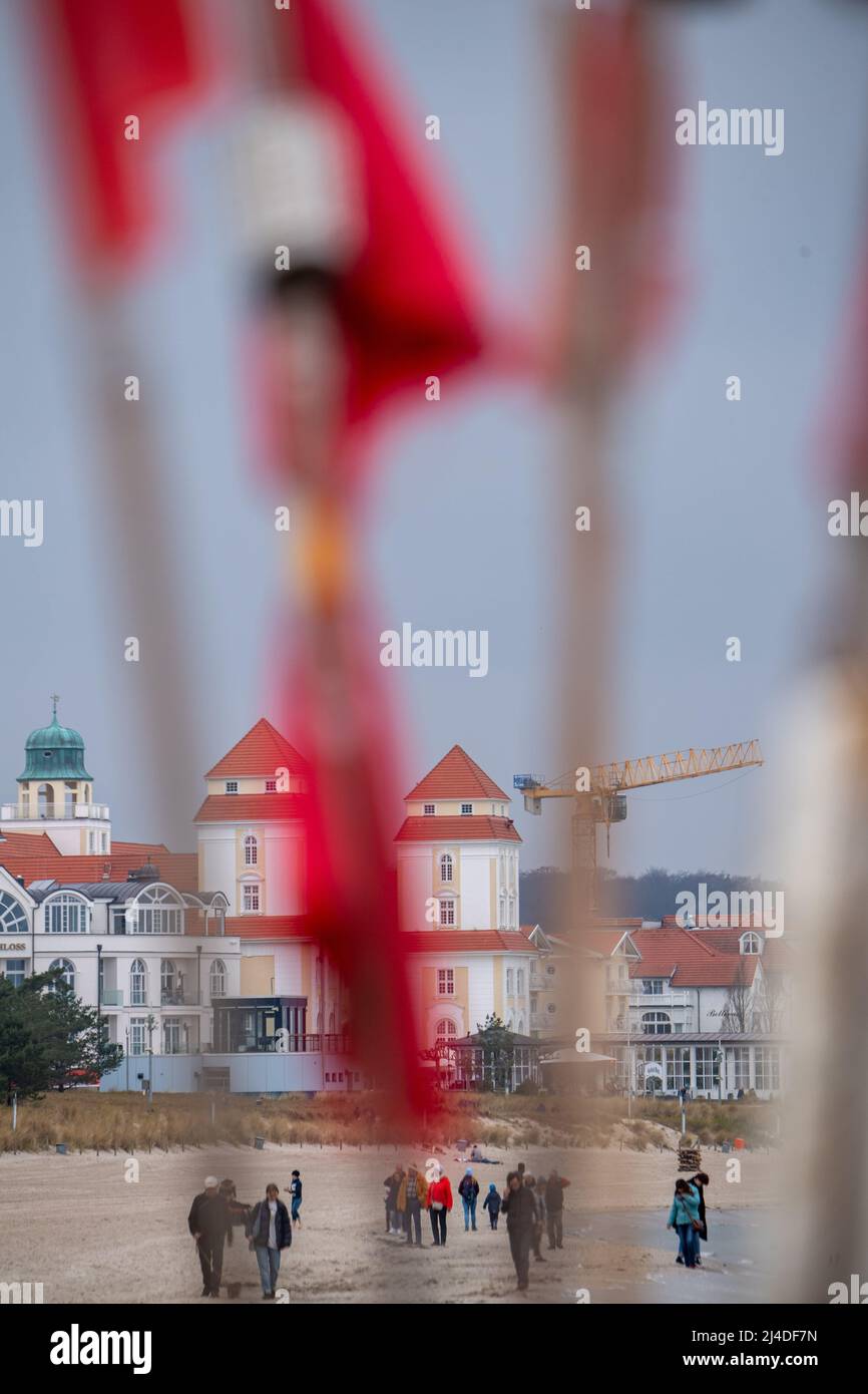 Binz, Germany. 14th Apr, 2022. Tourists walk along the beach in the ...