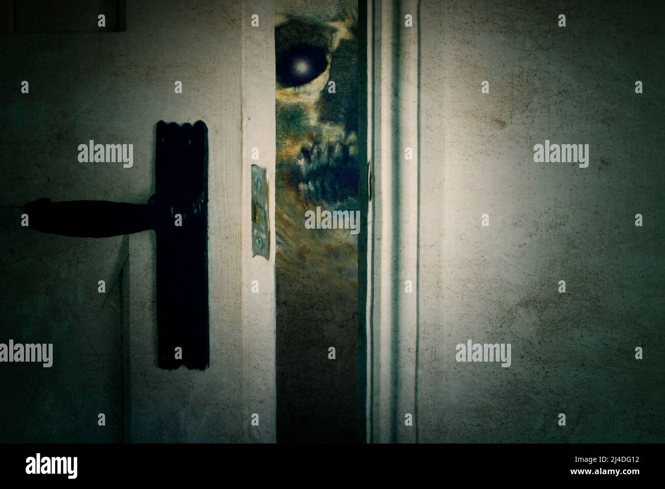 A scary zombie like demon looking through an open door way in a spooky ...