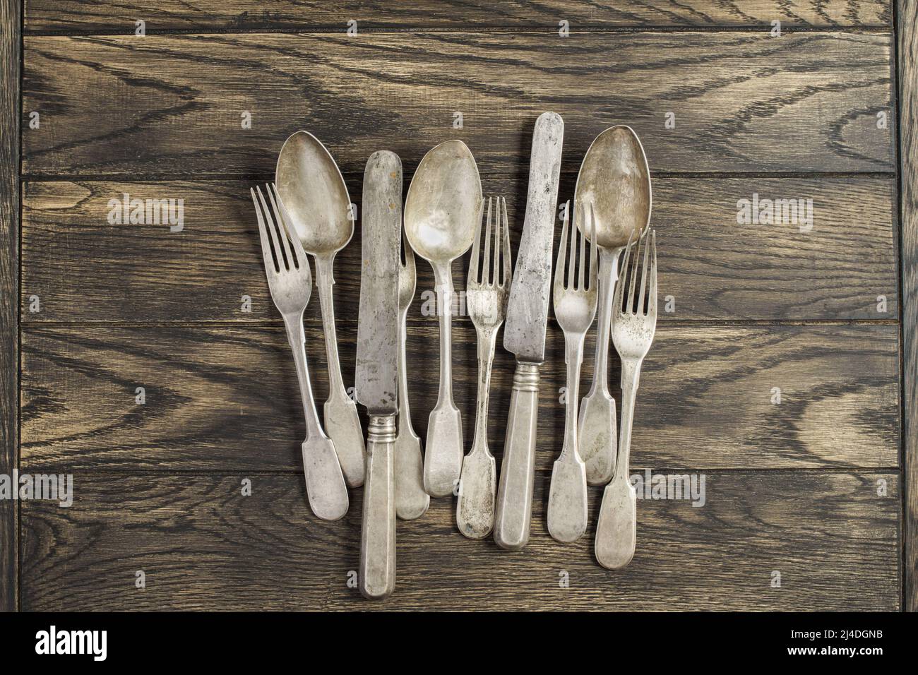 Vintage silverware on old oak wooden table top view Stock Photo - Alamy