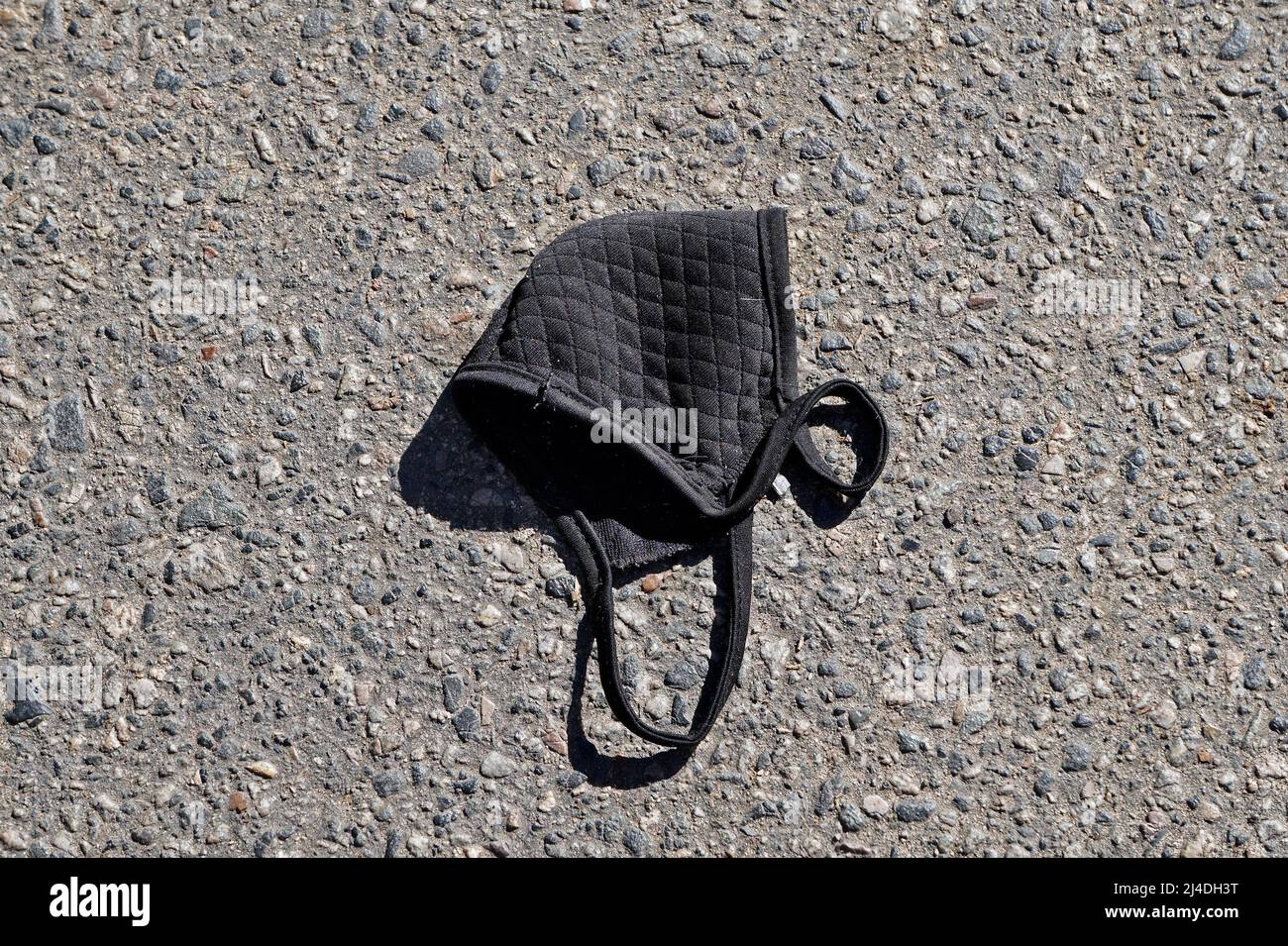 Face mask on floor in street. Improperly discarding used face mask ...