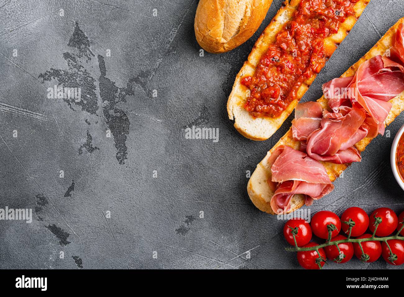 Traditional Spanish Jamon Serrano ham, on gray stone table background ...