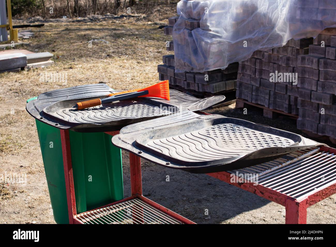 Rubber car mats and brush drying in the sun close up Stock Photo - Alamy