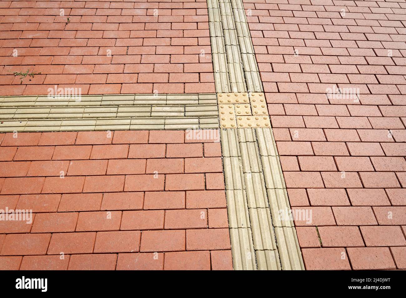 Textured walkway for blind people. Yellow tactile paving for the ...