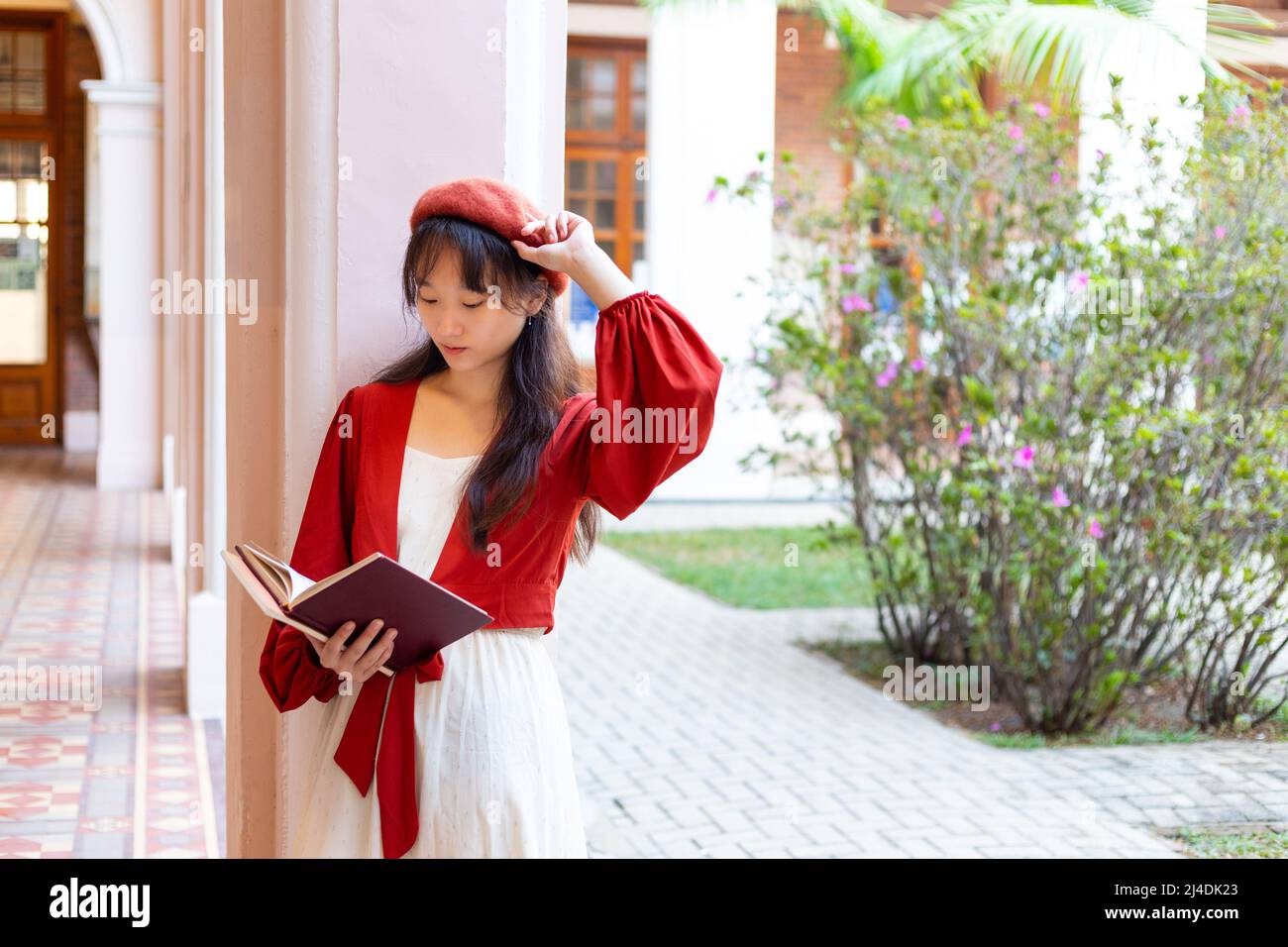 Happy stylish female research student read old school library book in ...