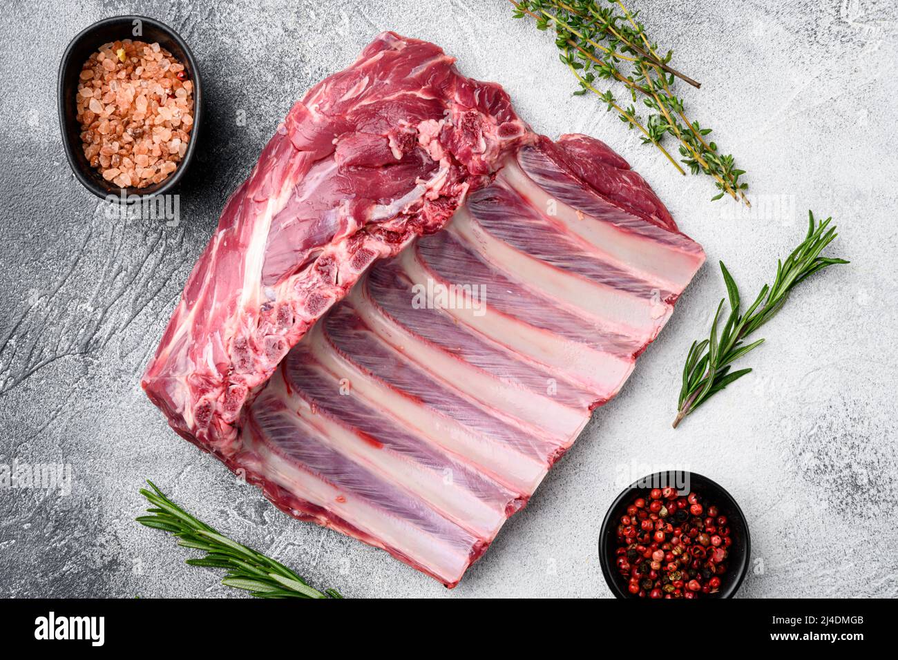 Rack of lamb , raw meat with bone, on gray stone table background, top ...