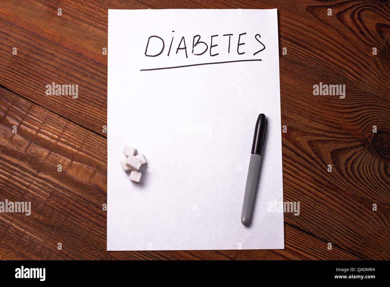 Stop Diabetes sign on a white paper sheet with sugar cubes on wooden ...