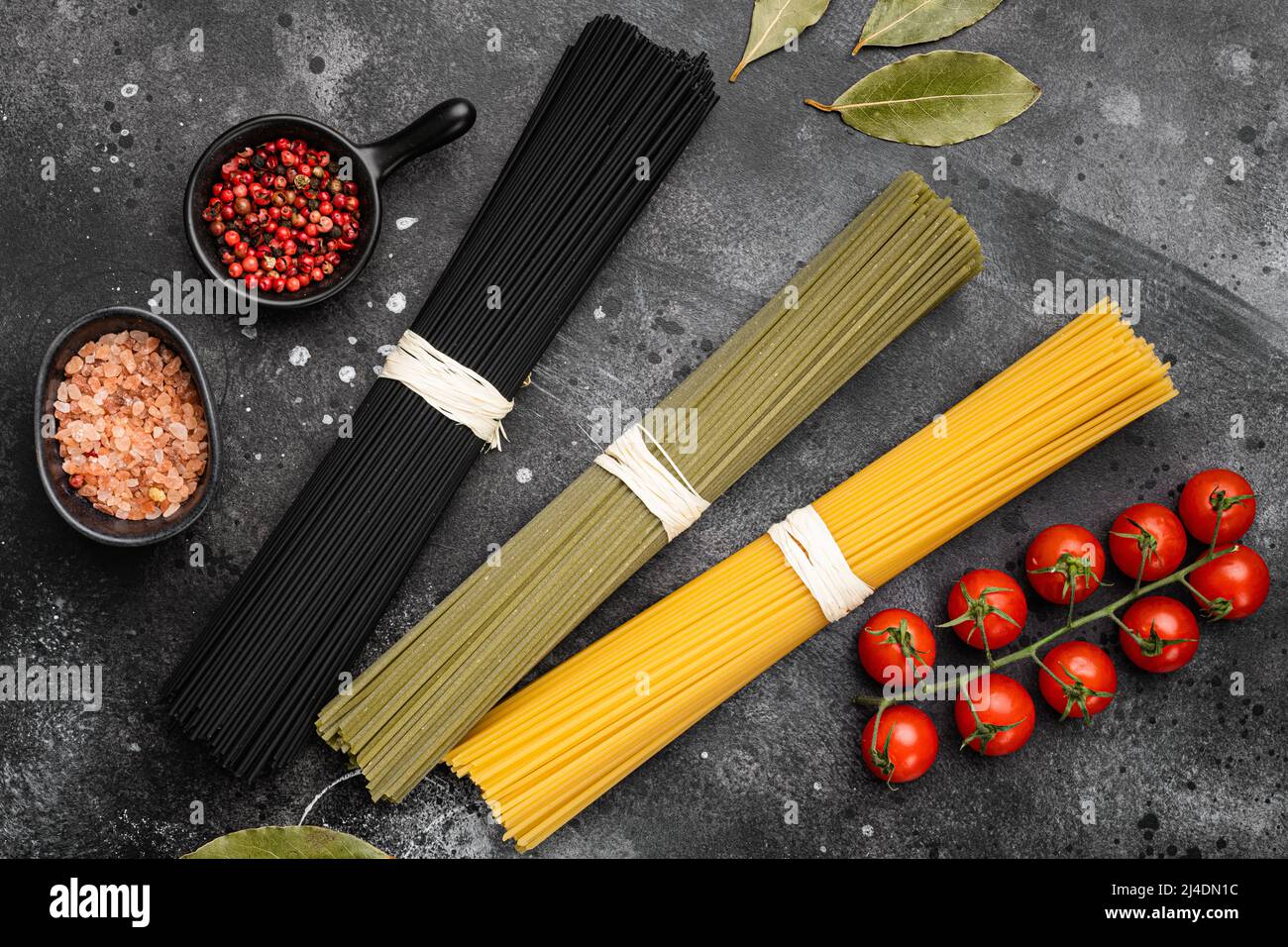 Multi colored pasta, on black dark stone table background, top view ...