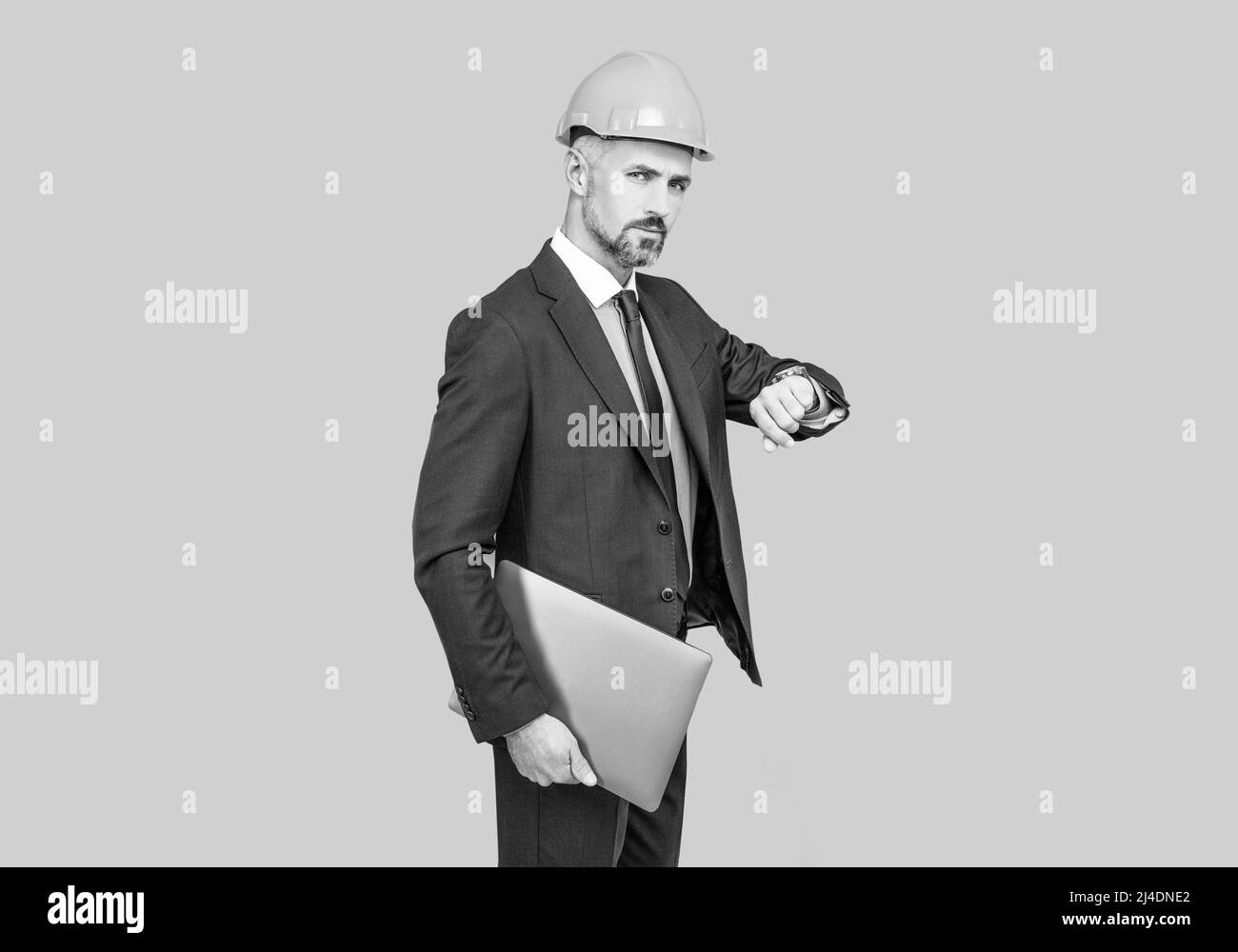 Businessman checking watch in office Black and White Stock Photos ...
