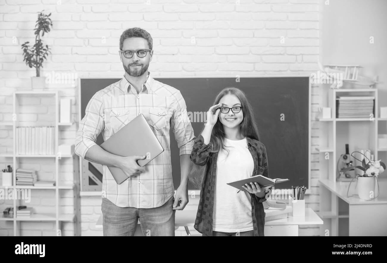 private teacher and child hold copybook. family help. dad and daughter ...