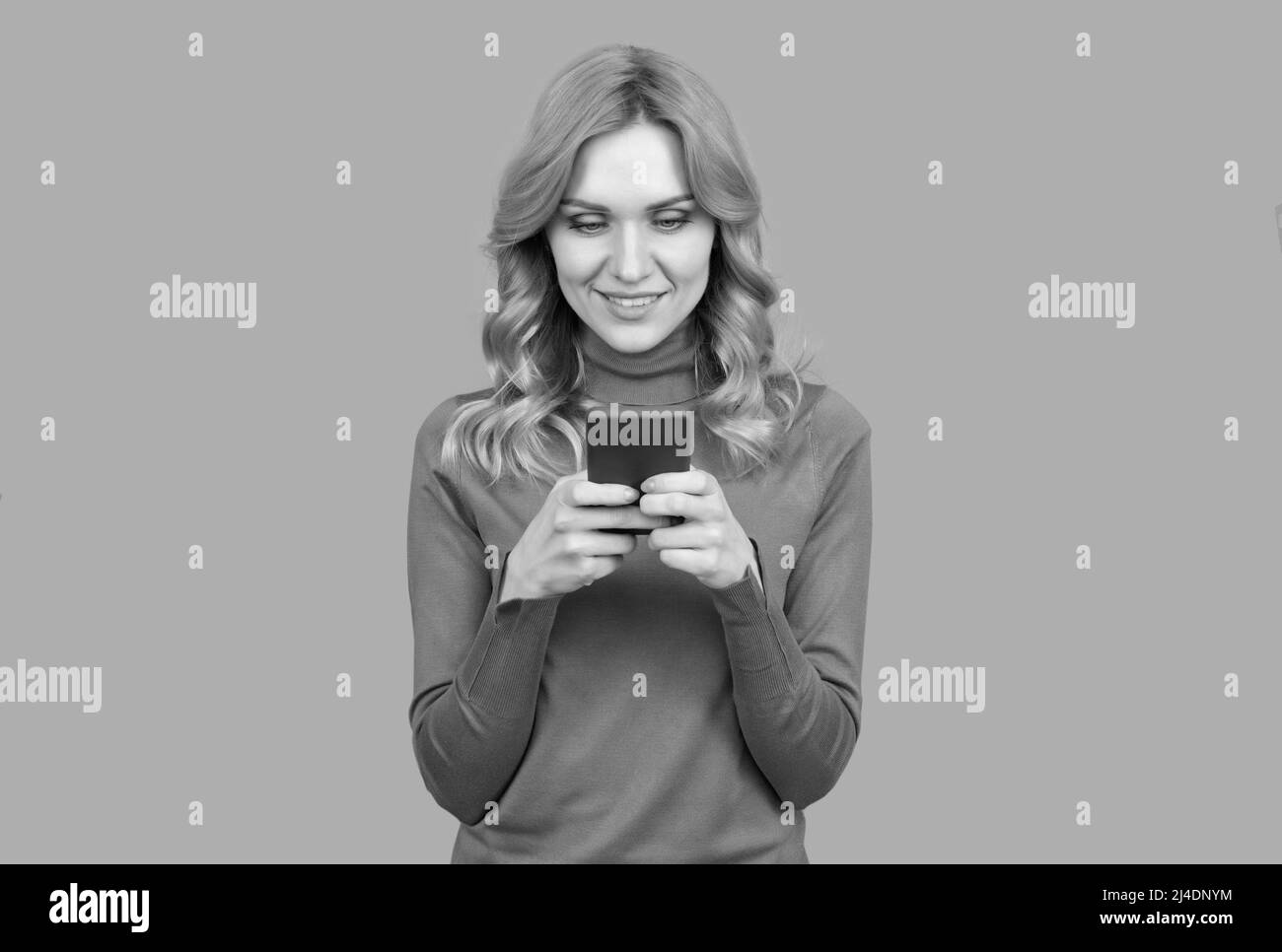 Pretty woman text short message on mobile phone device grey background ...