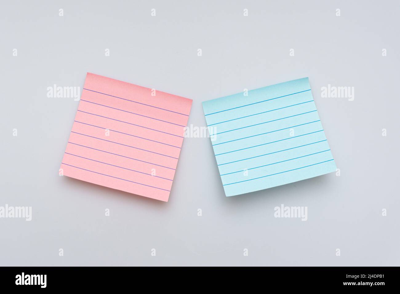 Various colored notepads scattered on a white background Stock Photo ...