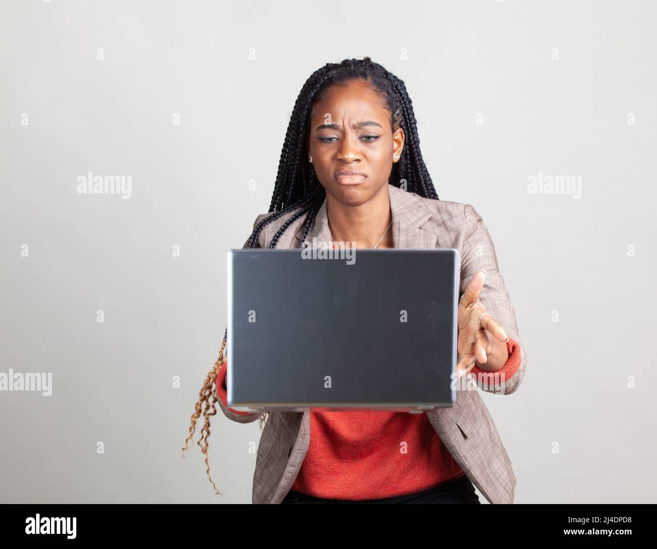 Young African American girl gets angry and throws laptop. Frustration ...