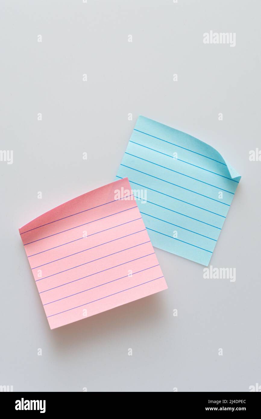 Various colored notepads scattered on a white background Stock Photo ...