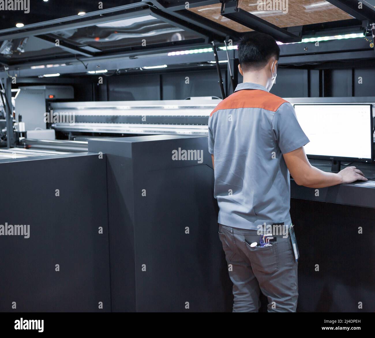 Industrial technician operating corrugated cardboard digital inkjet ...