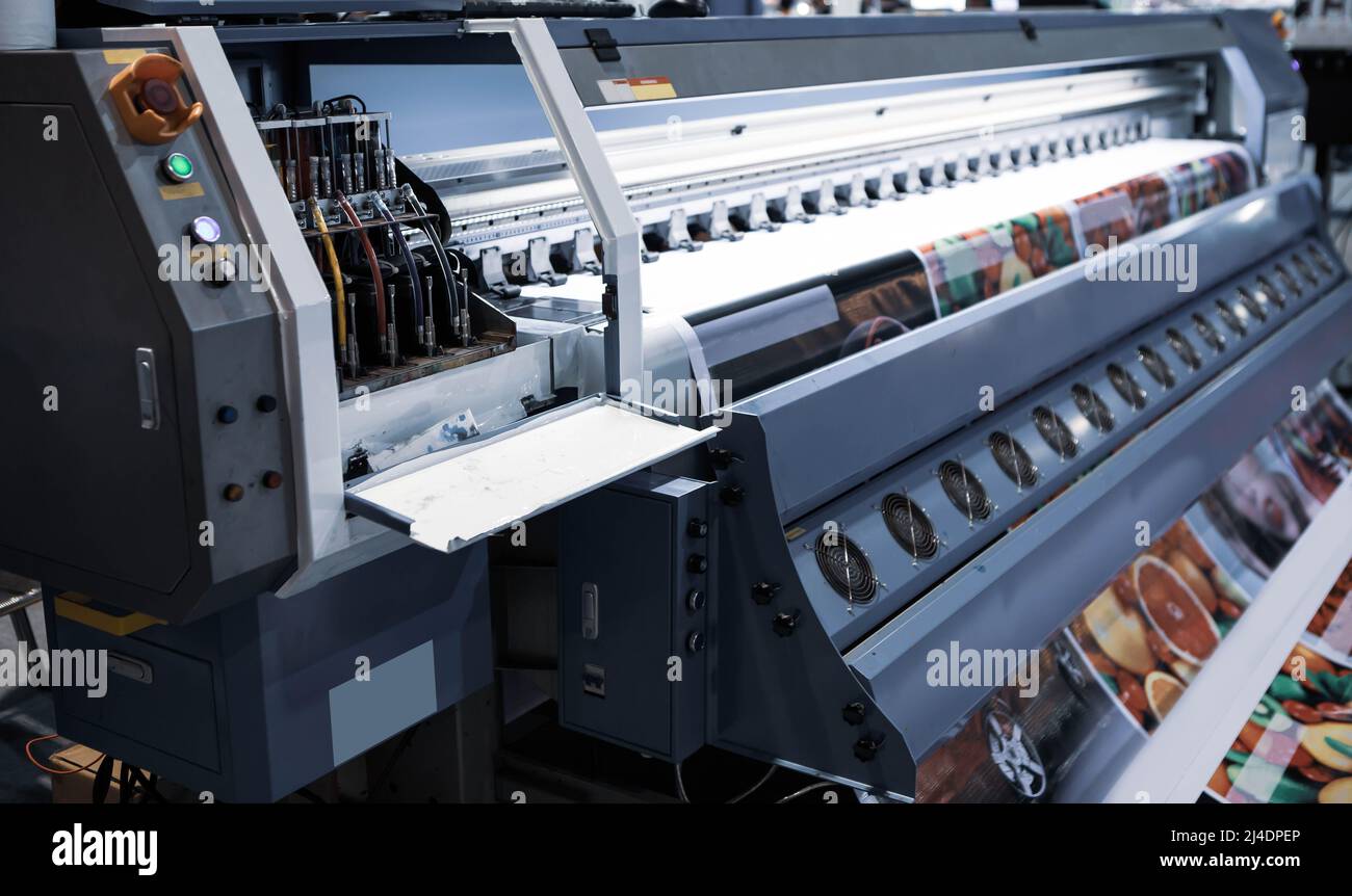 Wide format inkjet printer working on glossy poster. Advertising ...