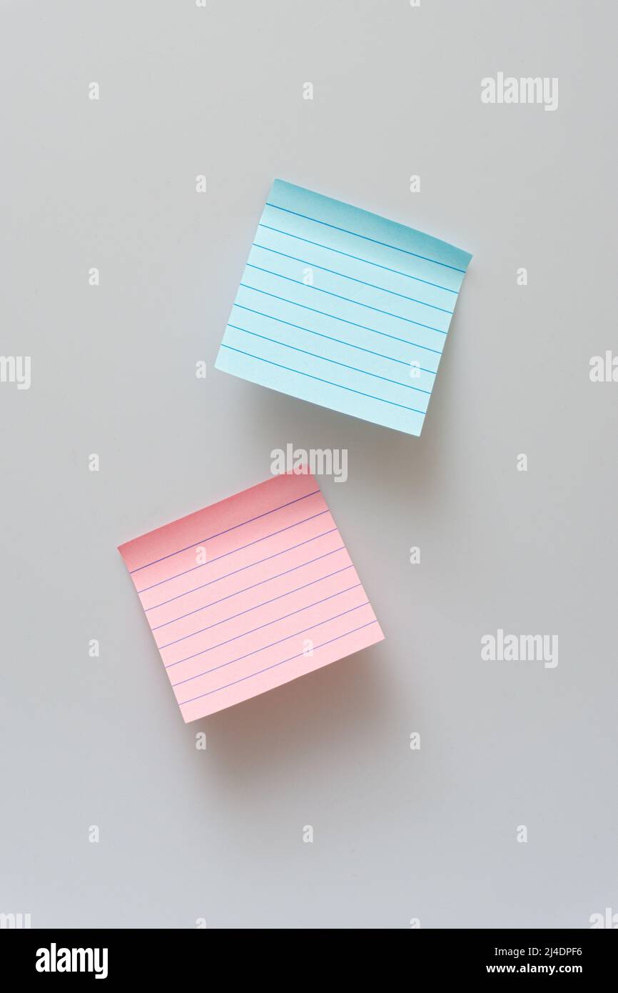 Various colored notepads scattered on a white background Stock Photo ...
