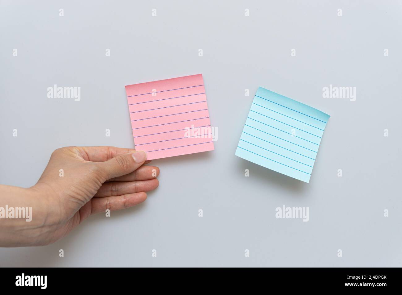 Various colored notepads scattered on a white background Stock Photo ...