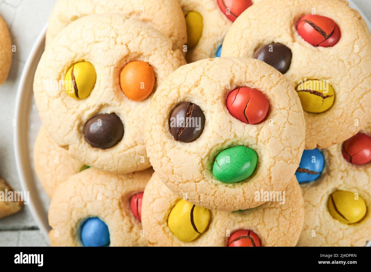 Homemade cookies with colorful chocolate candies and milk. Stack of ...