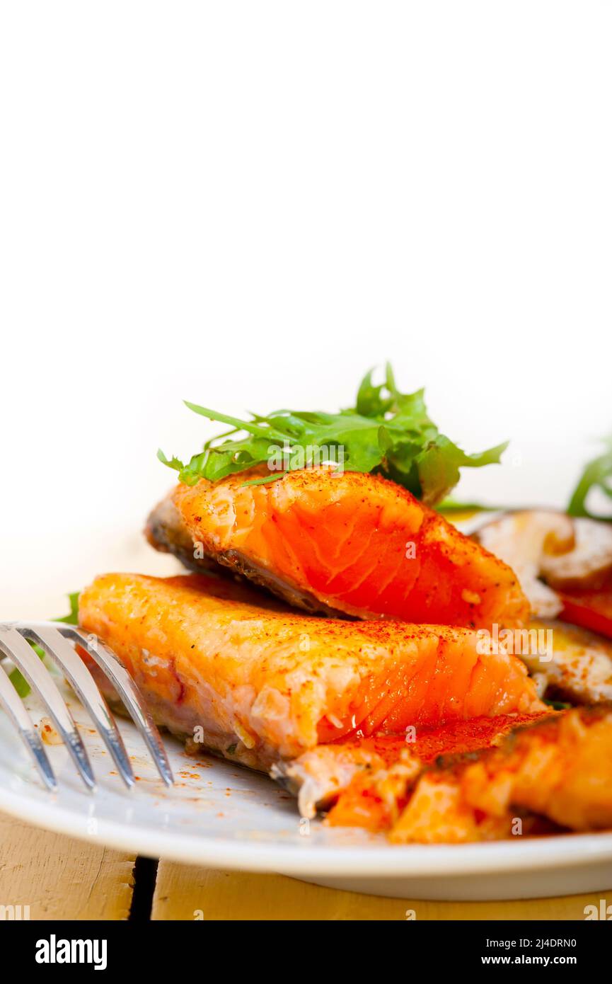 grilled fresh samon filet with vegetables salad tomato arugula ...