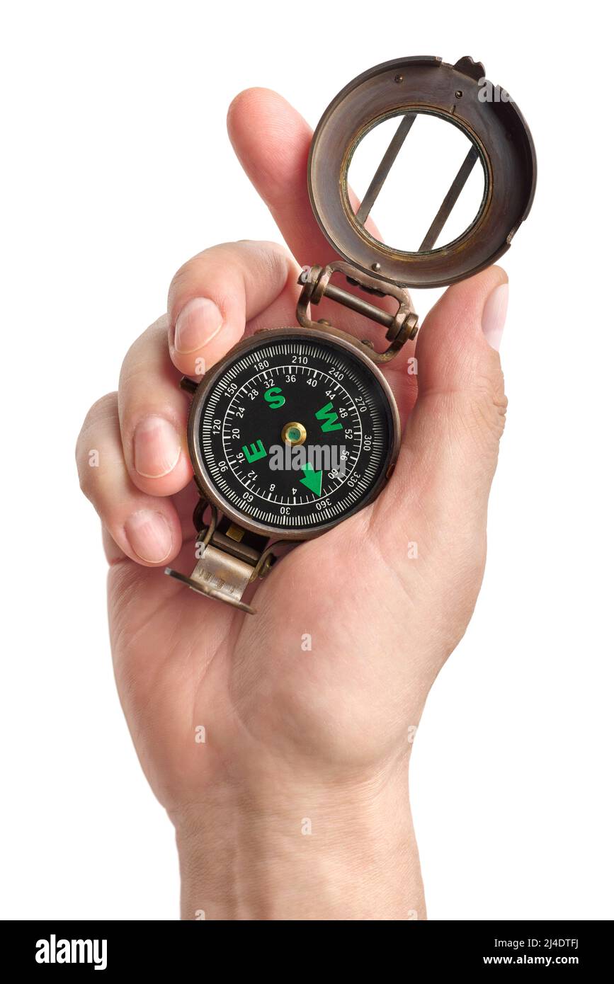 Hand holding traditional magnetic compass, vintage retro style ...