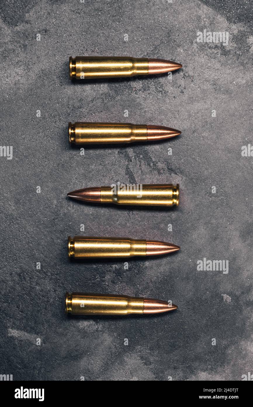 Bullets on gray background. One bullet positioned in opposite direction ...